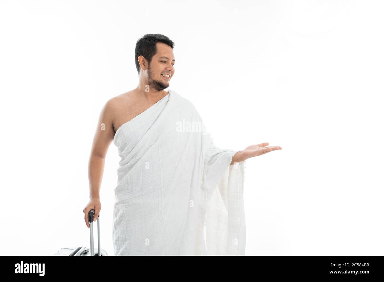 asian male with ihram presenting copyspace. hajj and umrah man concept ...