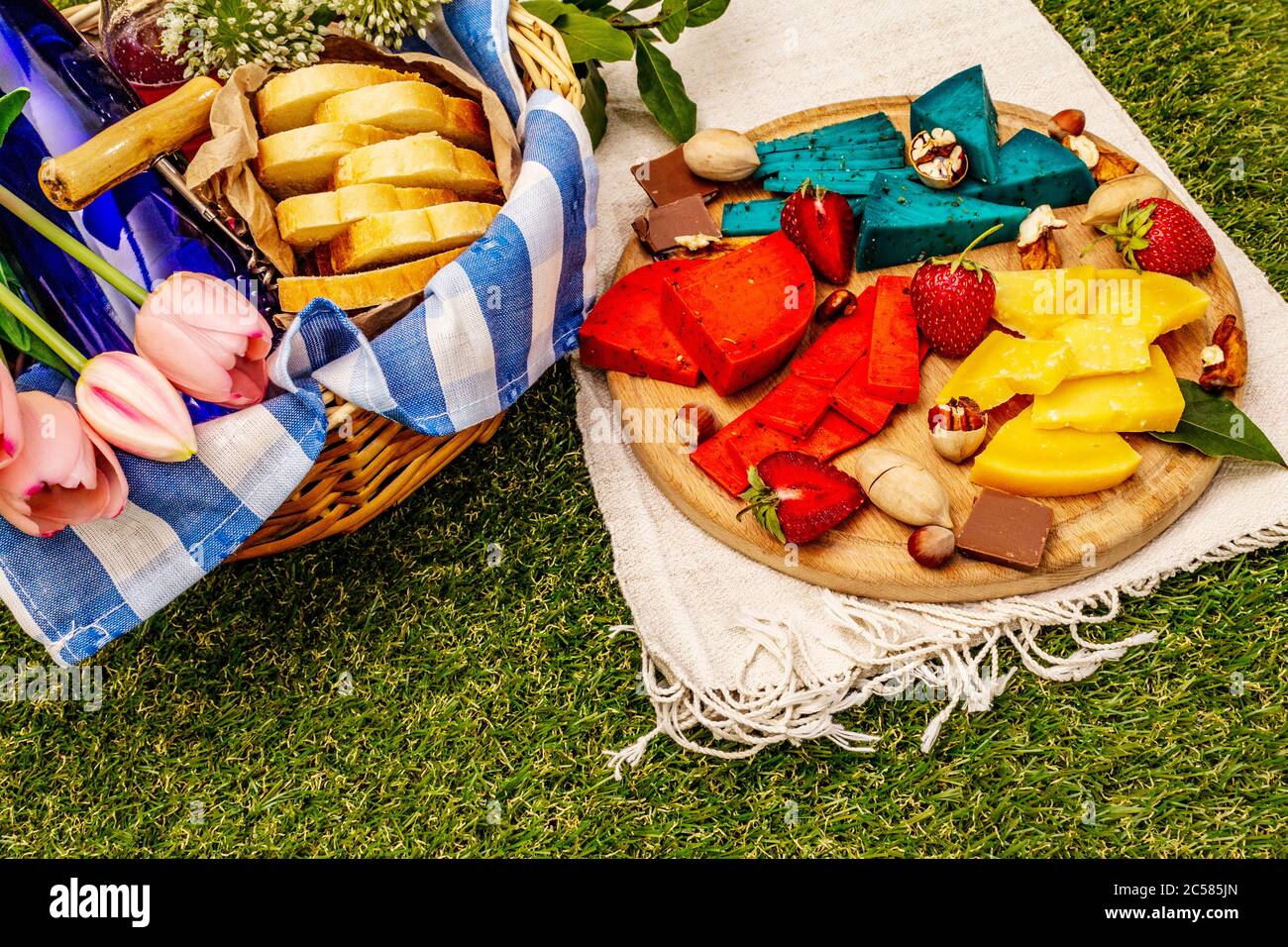 Picnic concept. Assorted multicolored hard Dutch cheeses. Blue and red ...