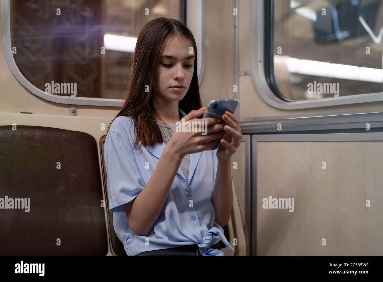 Teen girl rides the subway and used smartphone Stock Photo - Alamy