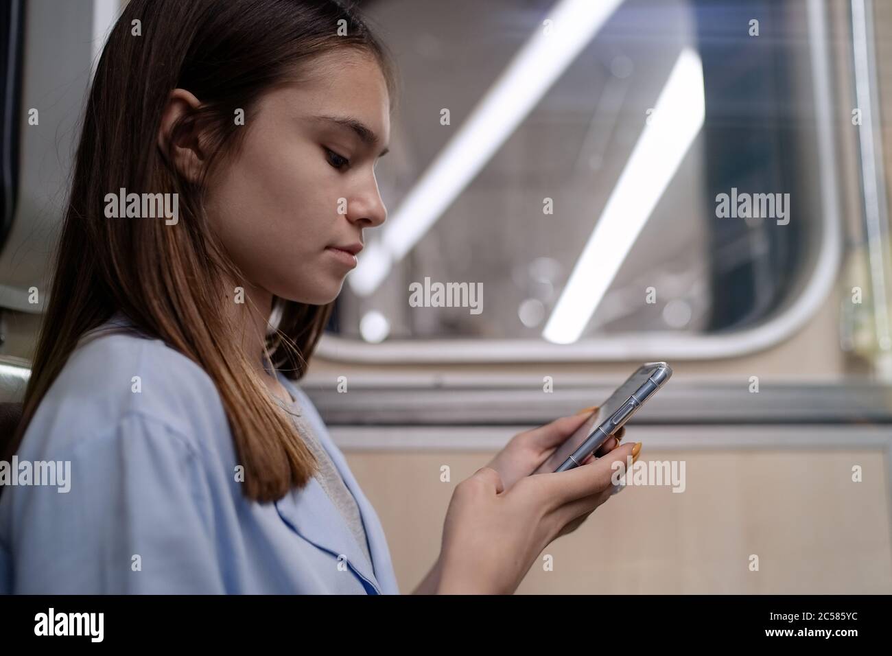Teen girl rides the subway and used smartphone Stock Photo - Alamy
