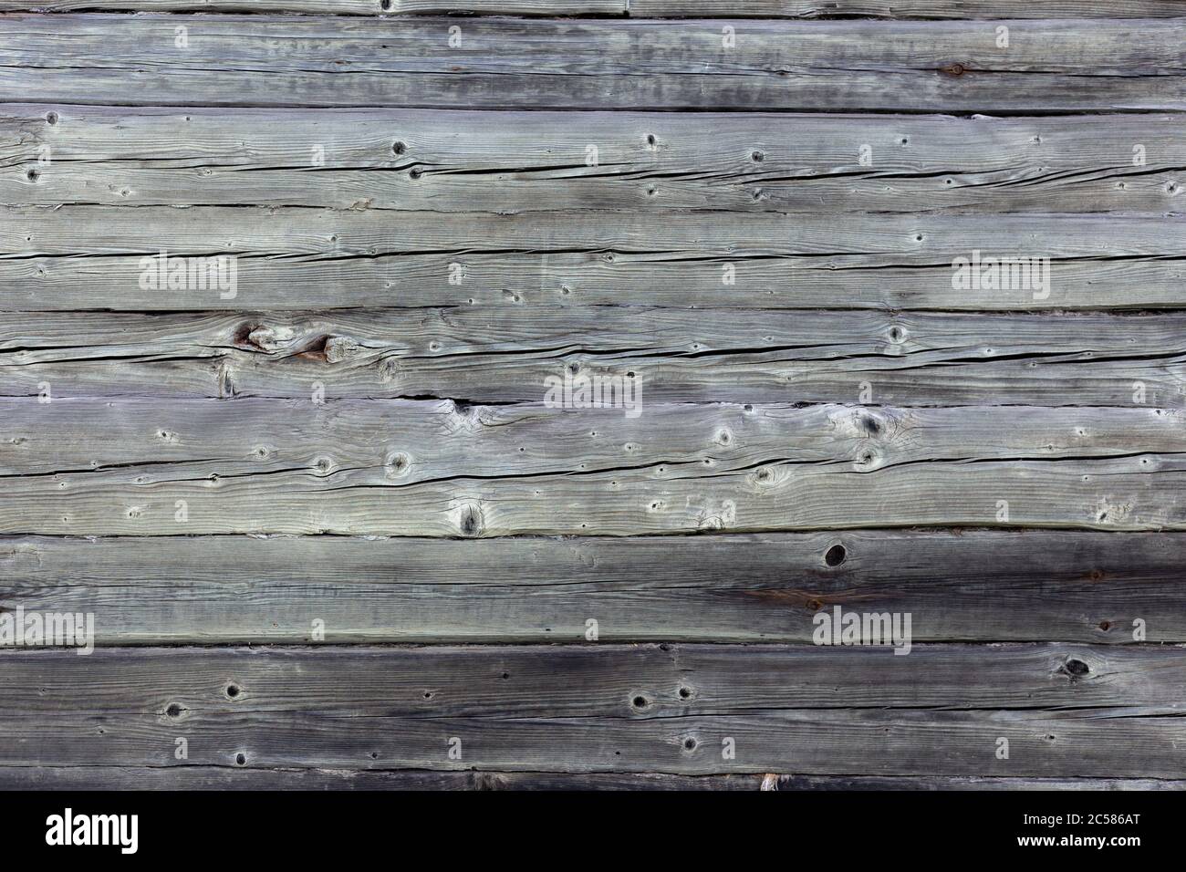 Wooden wall made of gray logs Stock Photo - Alamy