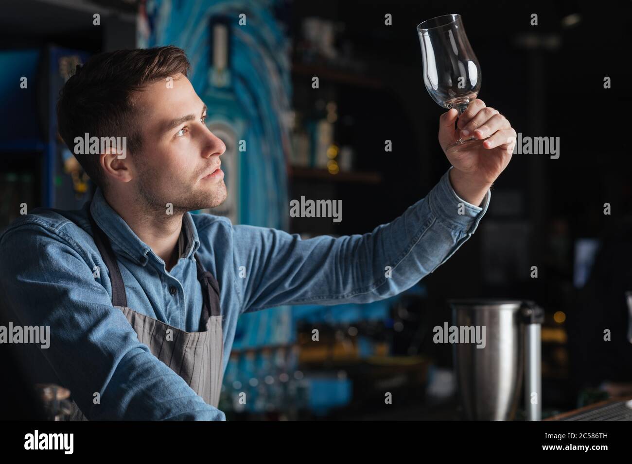 Perfect cleanliness. Professional bartender checks glass in pub Stock ...