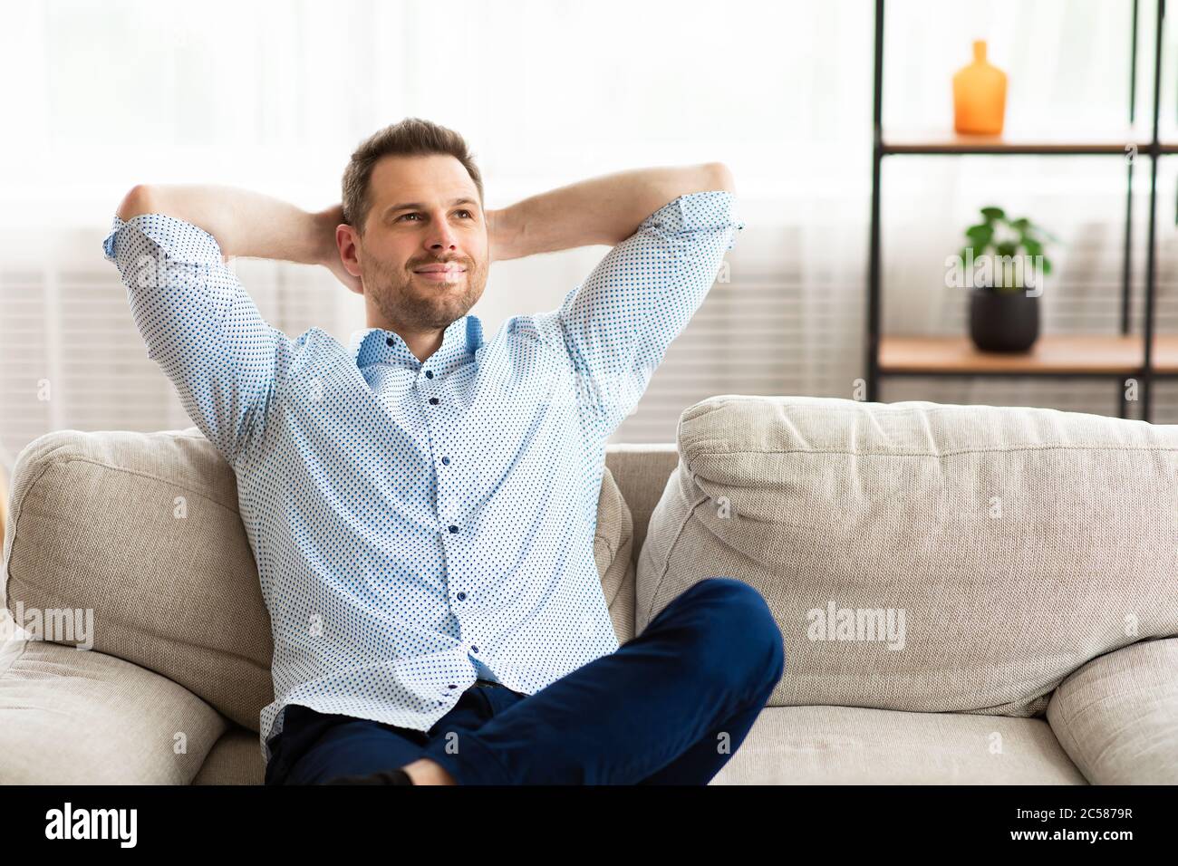 Man having rest at home on the sofa Stock Photo - Alamy