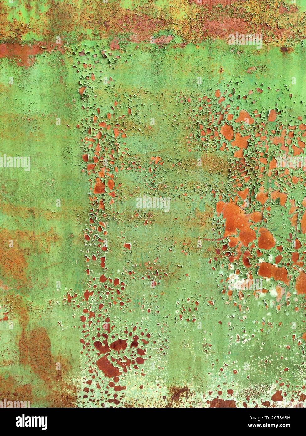 Rusty metal panel with cracked green and yellow paint, corroded grunge ...