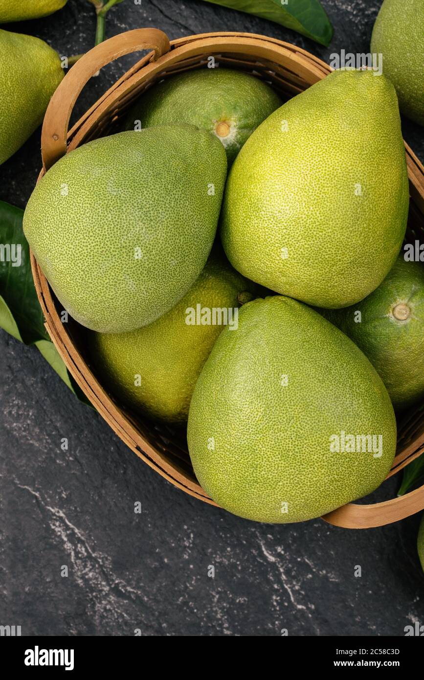 Fresh pomelo, pummelo, grapefruit, shaddock on black background, fruit ...