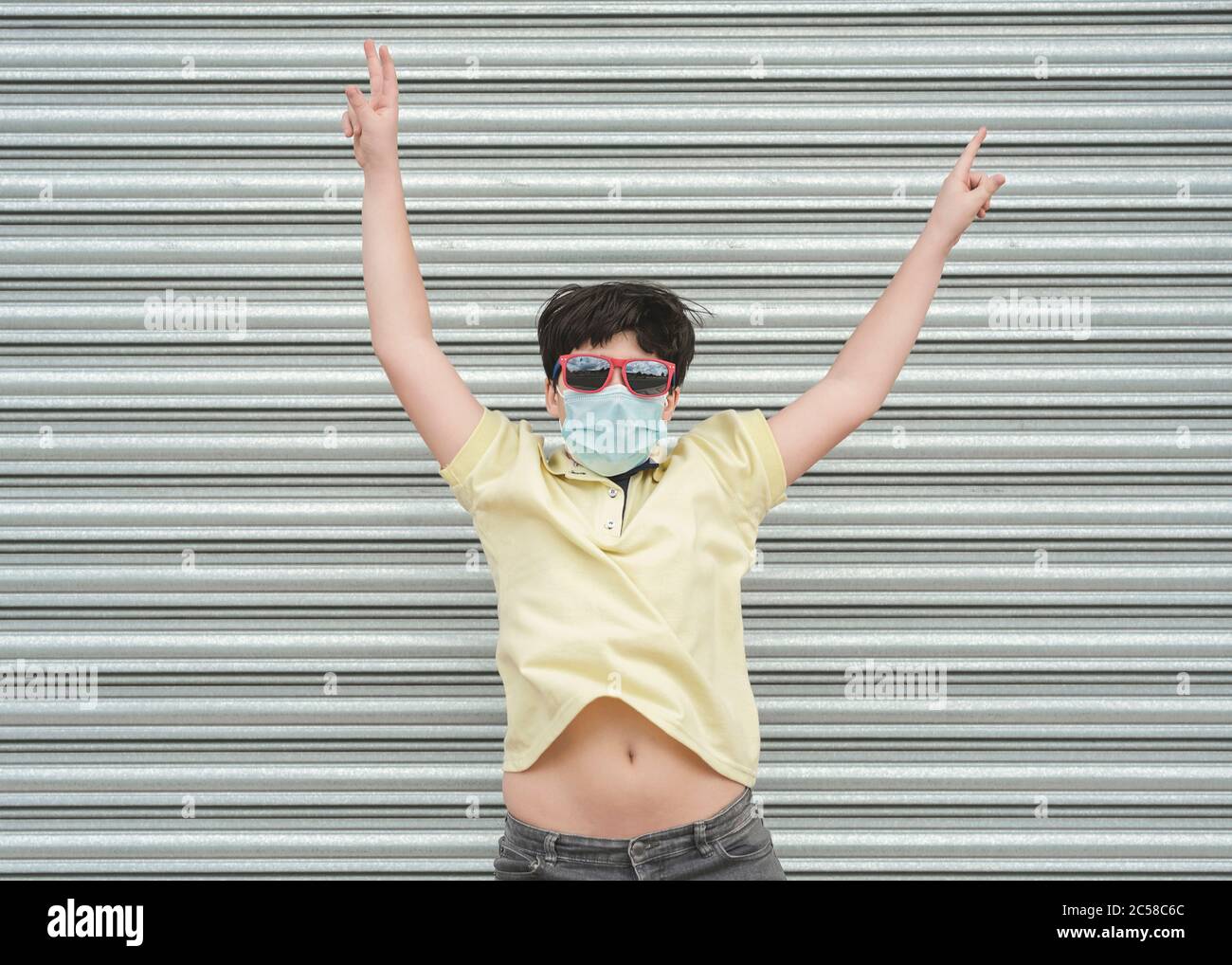 happy kid wearing medical mask jumping on the street outdoor Stock ...