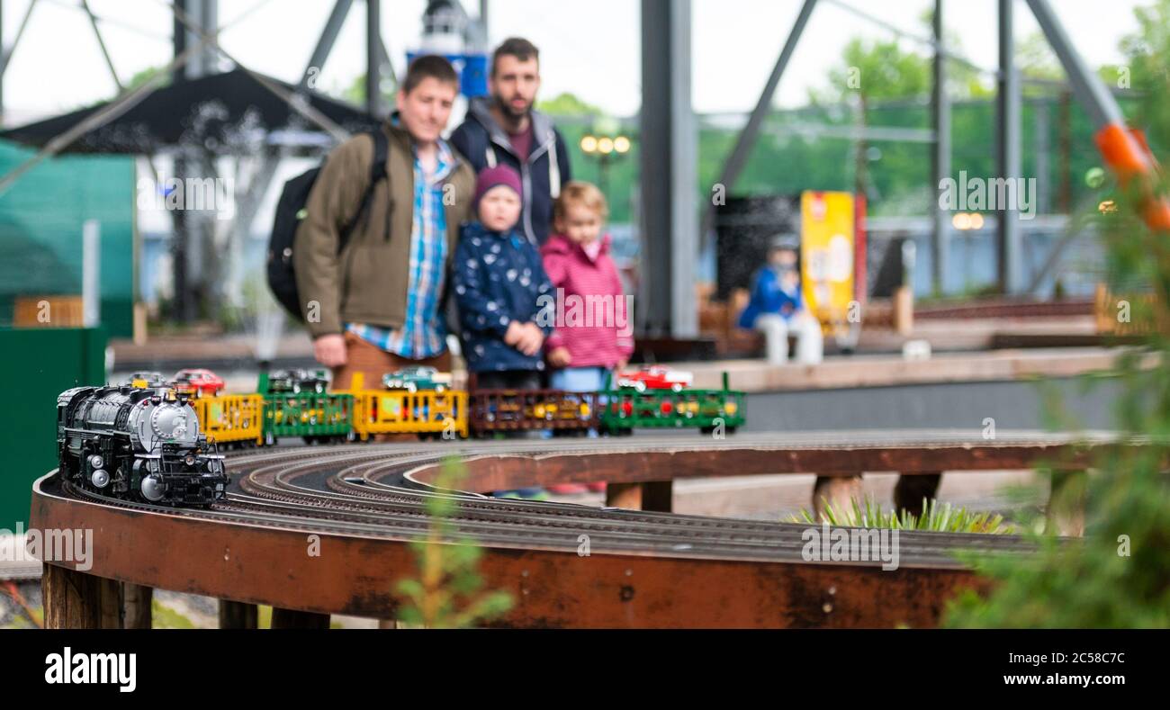 Bispingen, Germany. 01st July, 2020. Visitors look at a passing train ...