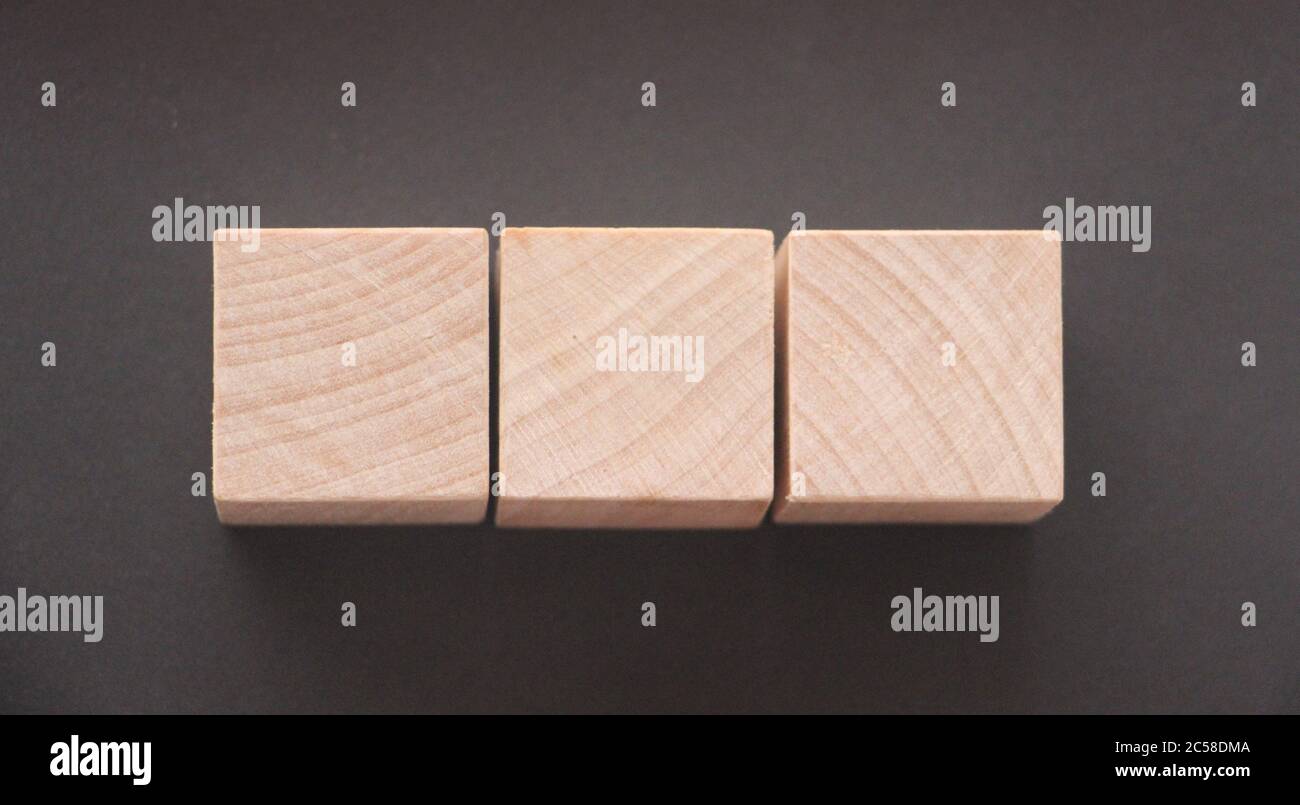 Wooden cube block shape withcopyspace on dark grey table Stock Photo ...
