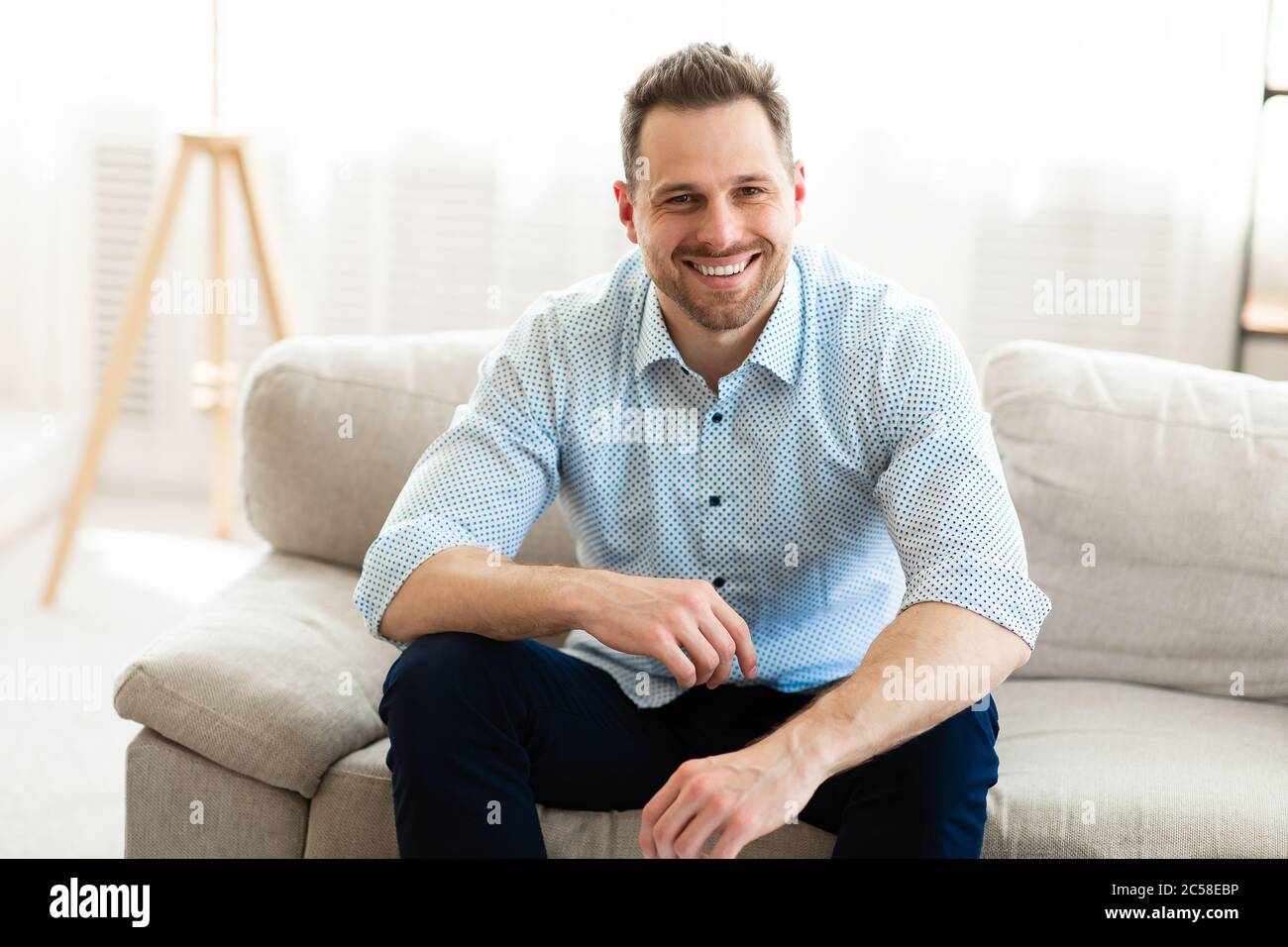 Happy man having rest at home on the sofa Stock Photo - Alamy
