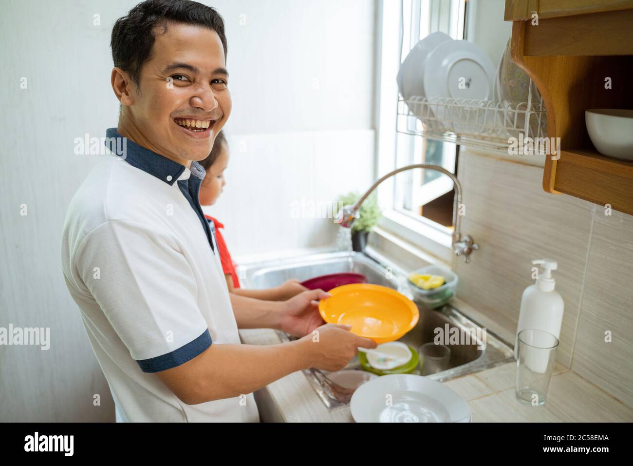 asian man washing the dishes in the kitchen at home Stock Photo - Alamy