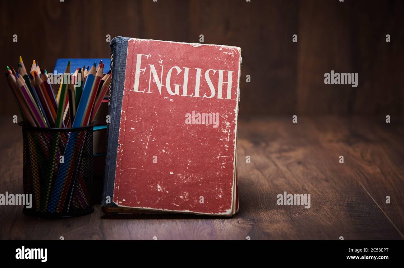 learning english concept. book on a wooden table background Stock Photo ...