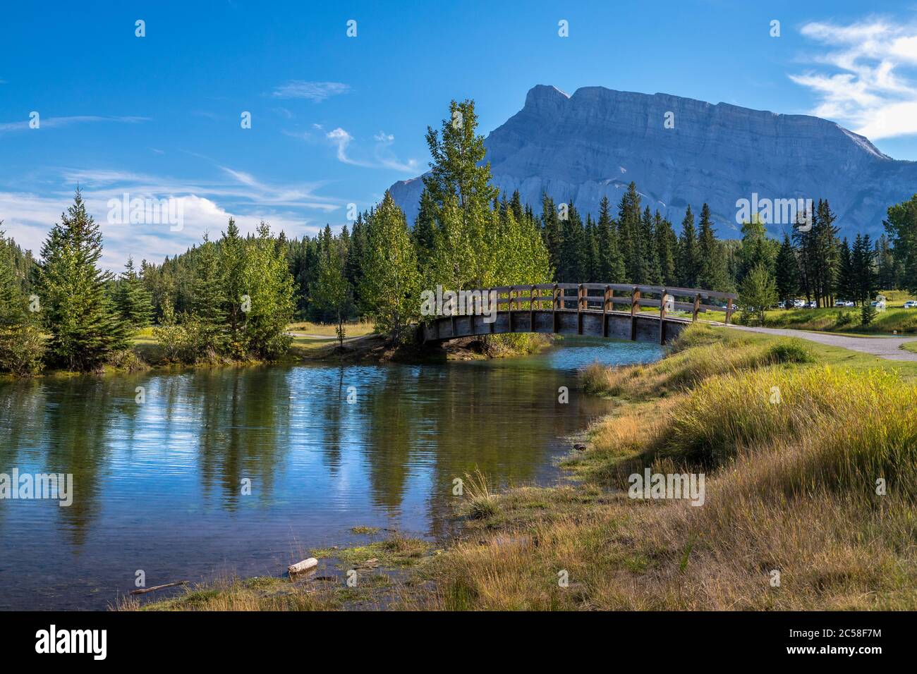 Beautiful wooden bridge spanning across Cascade Ponds with Mount Rundle ...