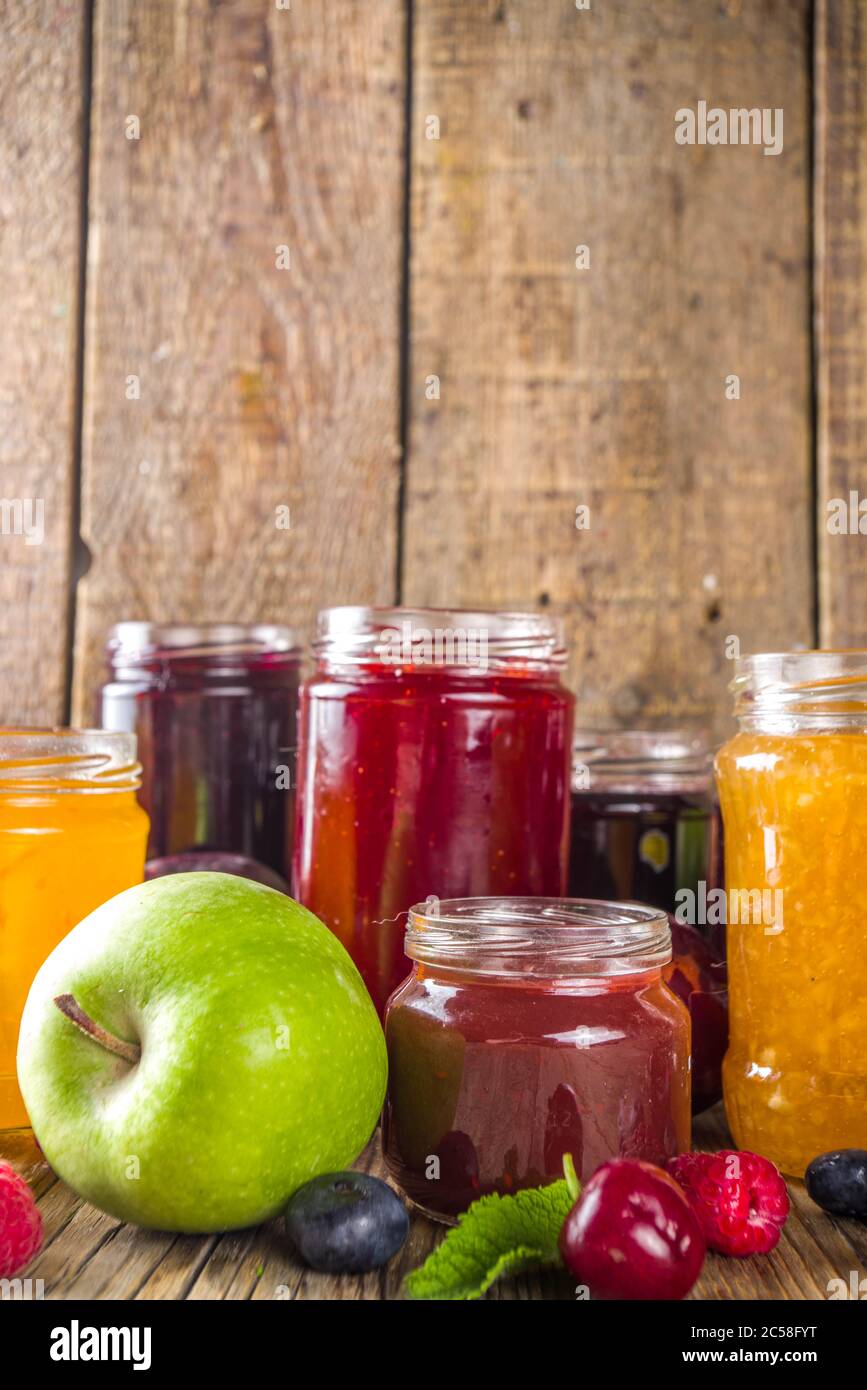 Assortment of berries and fruits jams. Set of various seasonal summer ...