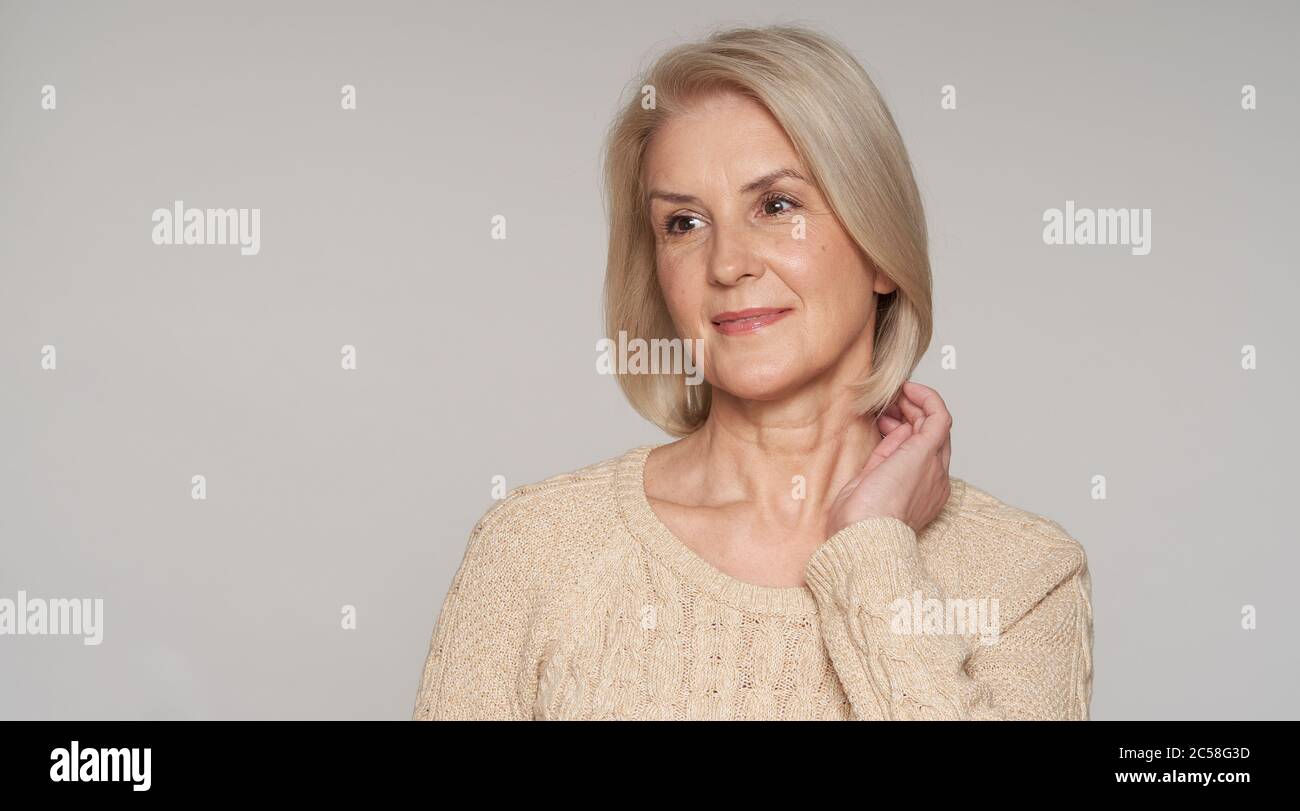 portrait of beautiful senior woman smiling. 50s years old blonde lady ...