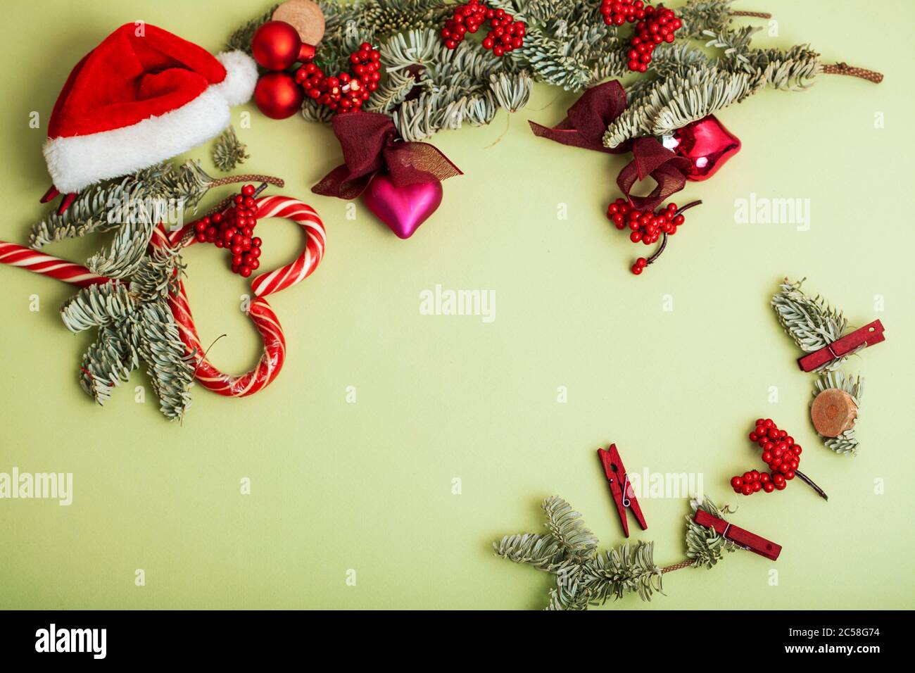 christmass stuff laying flat on colorful background, branch of tree ...