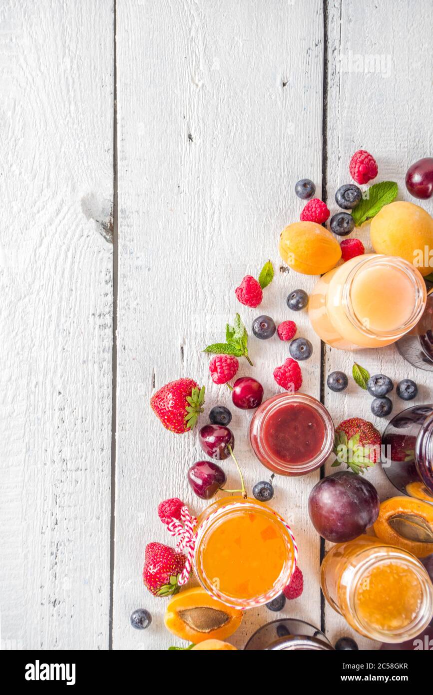 Assortment of berries and fruits jams. Set of various seasonal summer ...