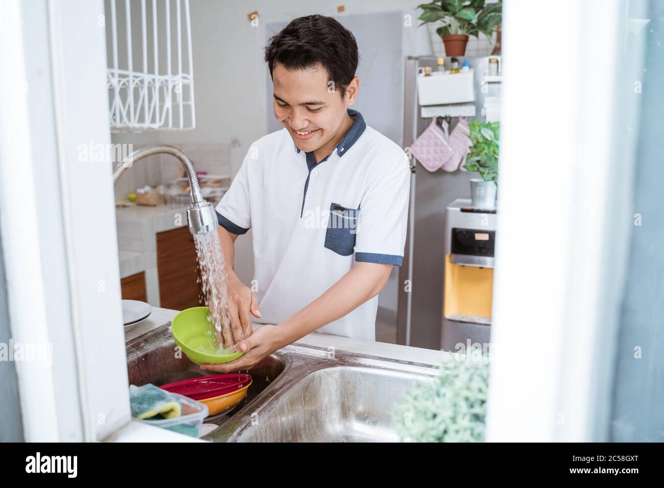 asian man washing the dishes in the kitchen at home Stock Photo - Alamy