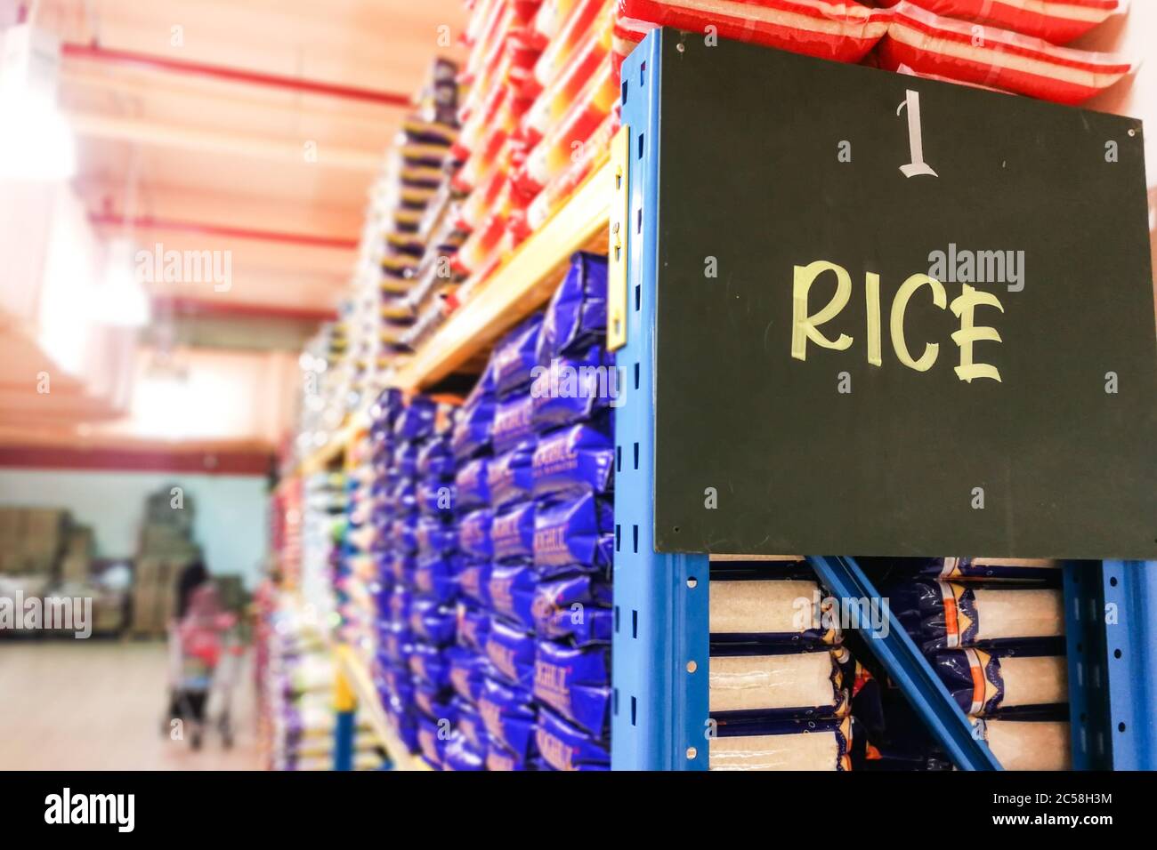 Rice signage at the aisle of supermarket with defocused merchandise on ...