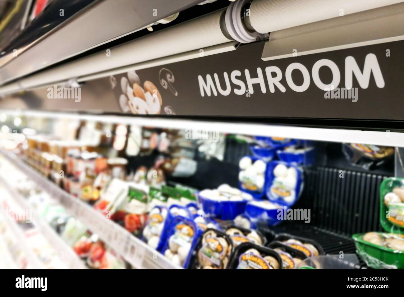 Mushroom signage at supermarket produced food section with defocused ...