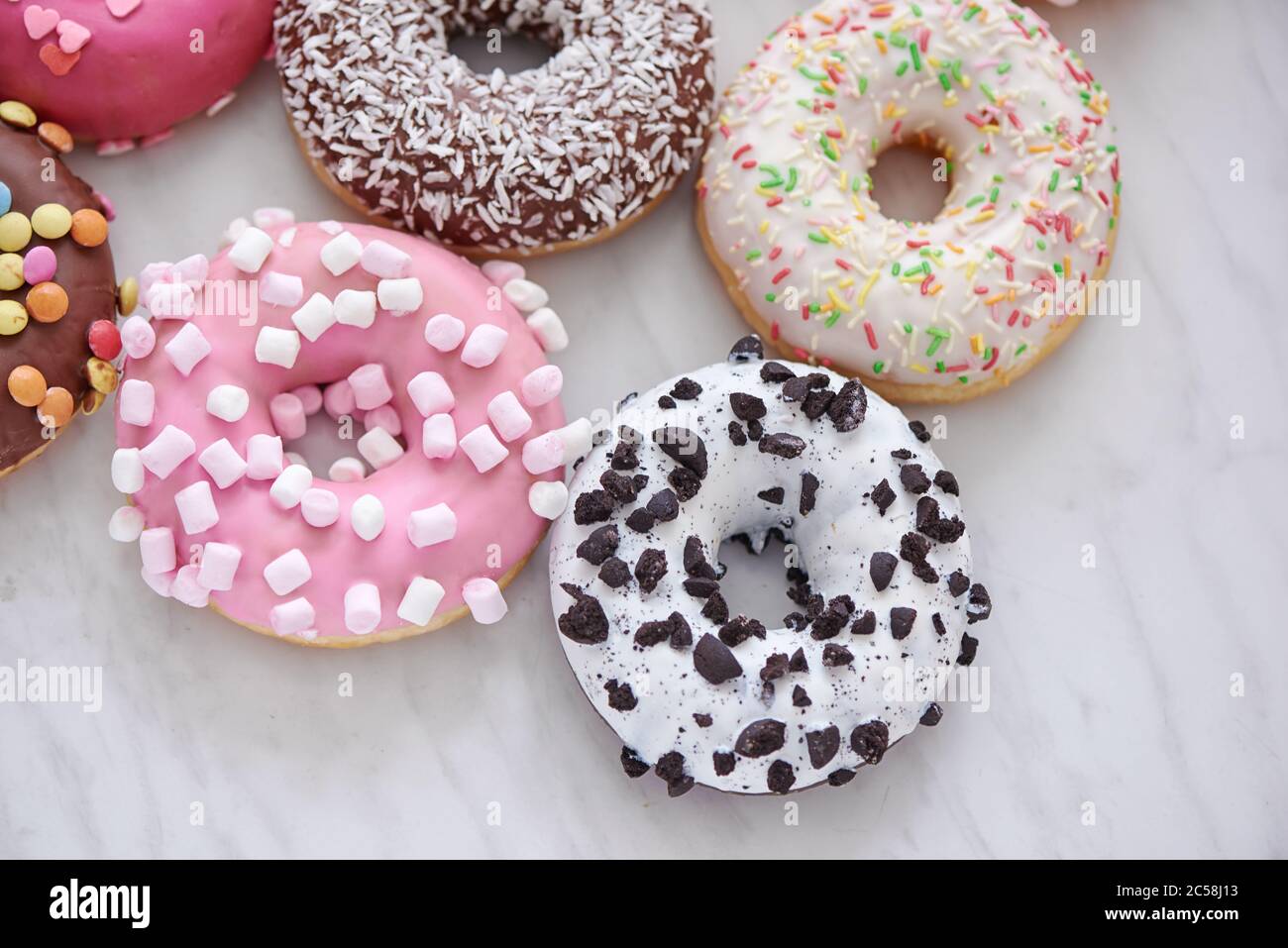 Donut with colorful sprinkles. Top view Stock Photo - Alamy
