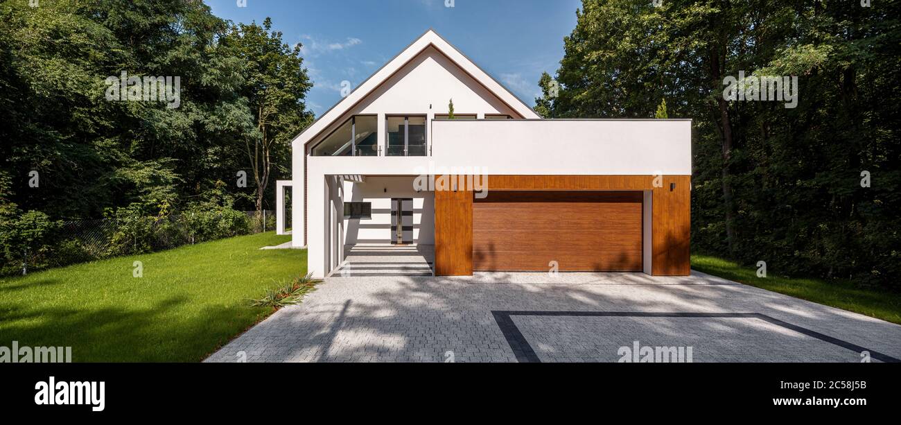 Exterior view of elegant house with cobblestone driveway, panorama ...