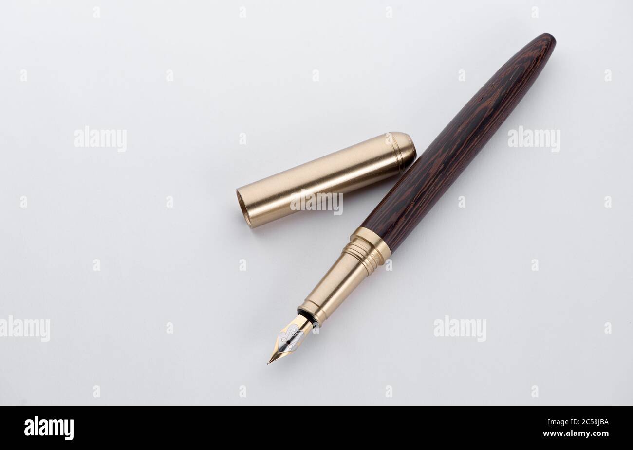 Fountain writing pen on a white paper sheet Stock Photo - Alamy