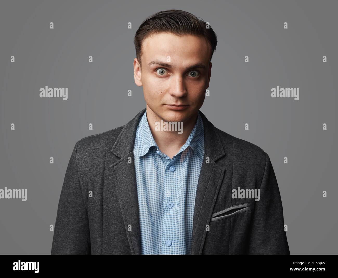 Shocked handsome man with wide opened eyes. Studio isolated Stock Photo ...