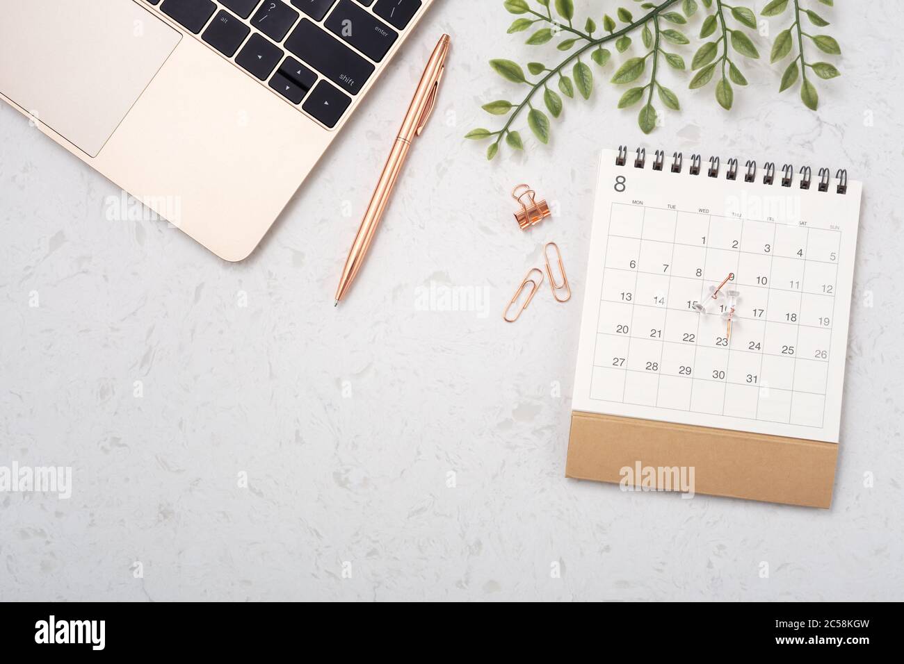Calendar with laptop on white quartz table, save the date concept, flat ...