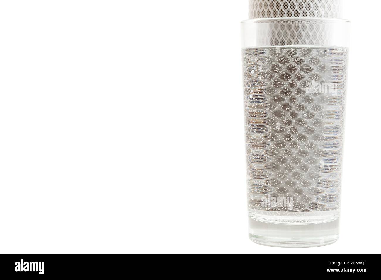 a glass cup filled with clean filtered water from the back of a ...