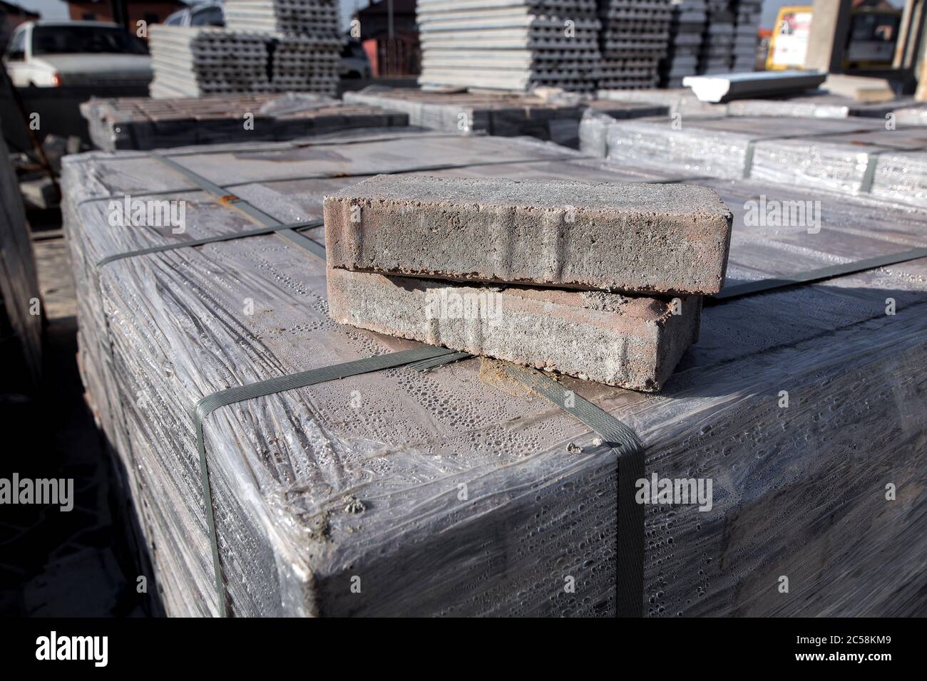 new paving stone tiles folded and packed on a pallet on sunny day ...