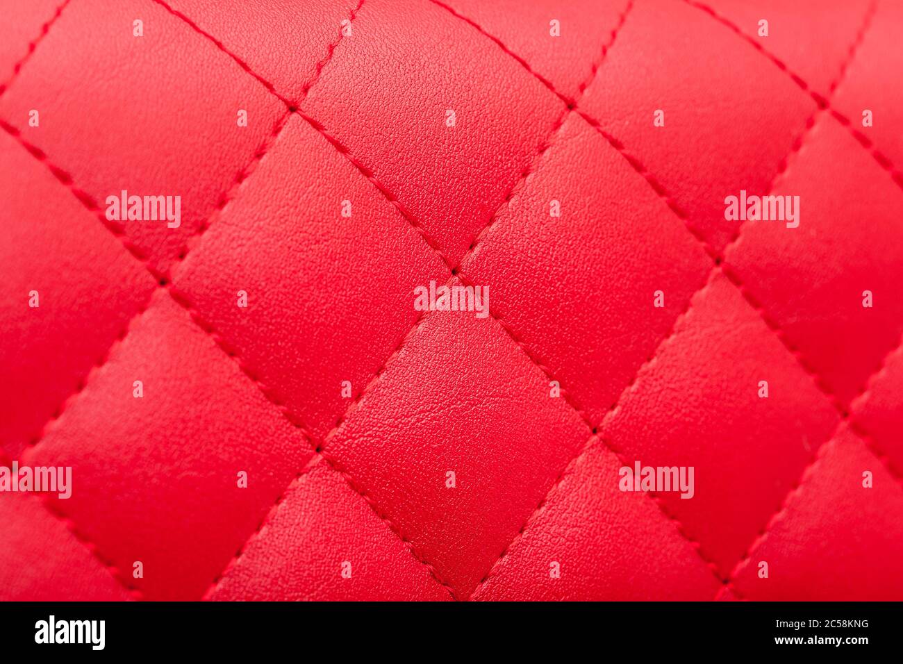 red leather pattern stitched squares with thread seam, decorative ...