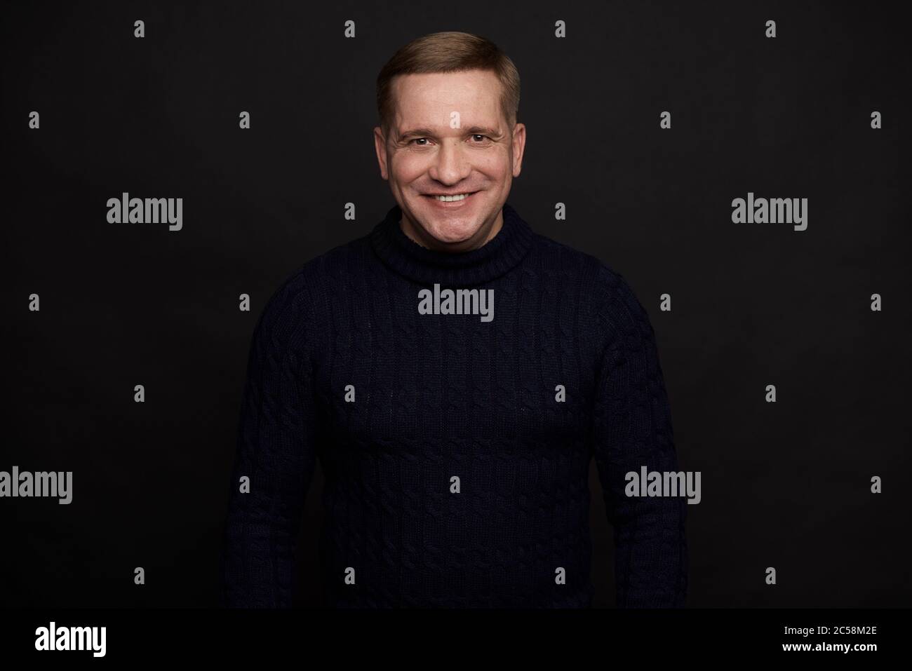 Happy middle aged man over black background. Studio shot Stock Photo ...