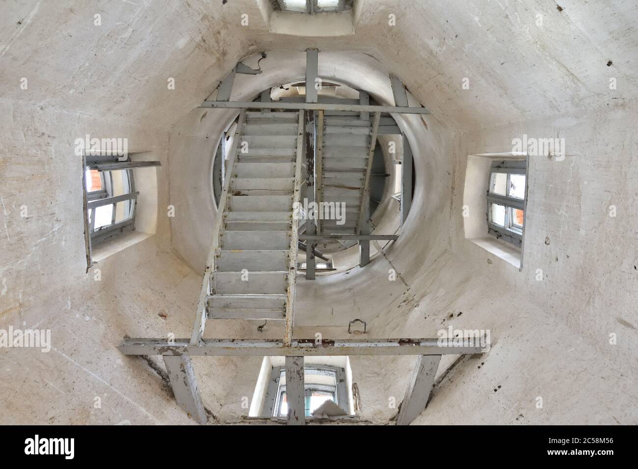 The interior of an abandoned and neglected tower with windows and ...