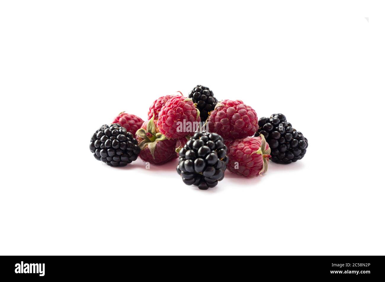 Ripe raspberries and blackberries isolated on white background ...