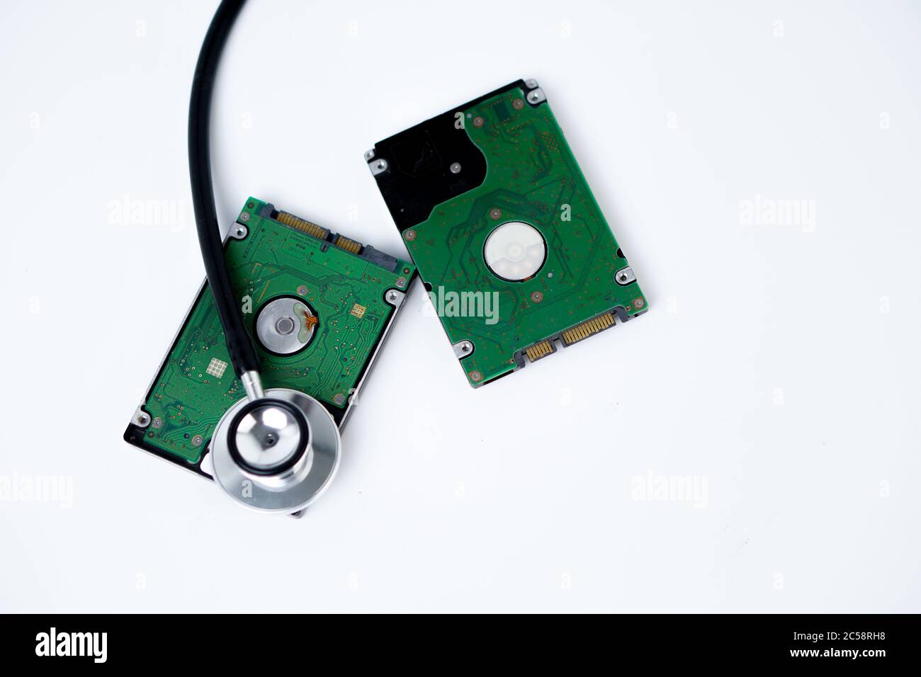 A hard disk with a stethoscope isolated on white background. Recovery ...
