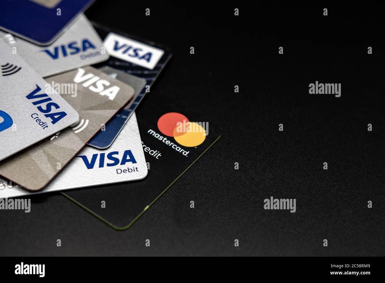 Stack of credit and debit cards from well-known finance companies ...