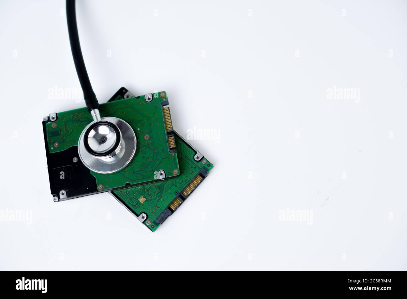 A hard disk with a stethoscope isolated on white background. Recovery ...
