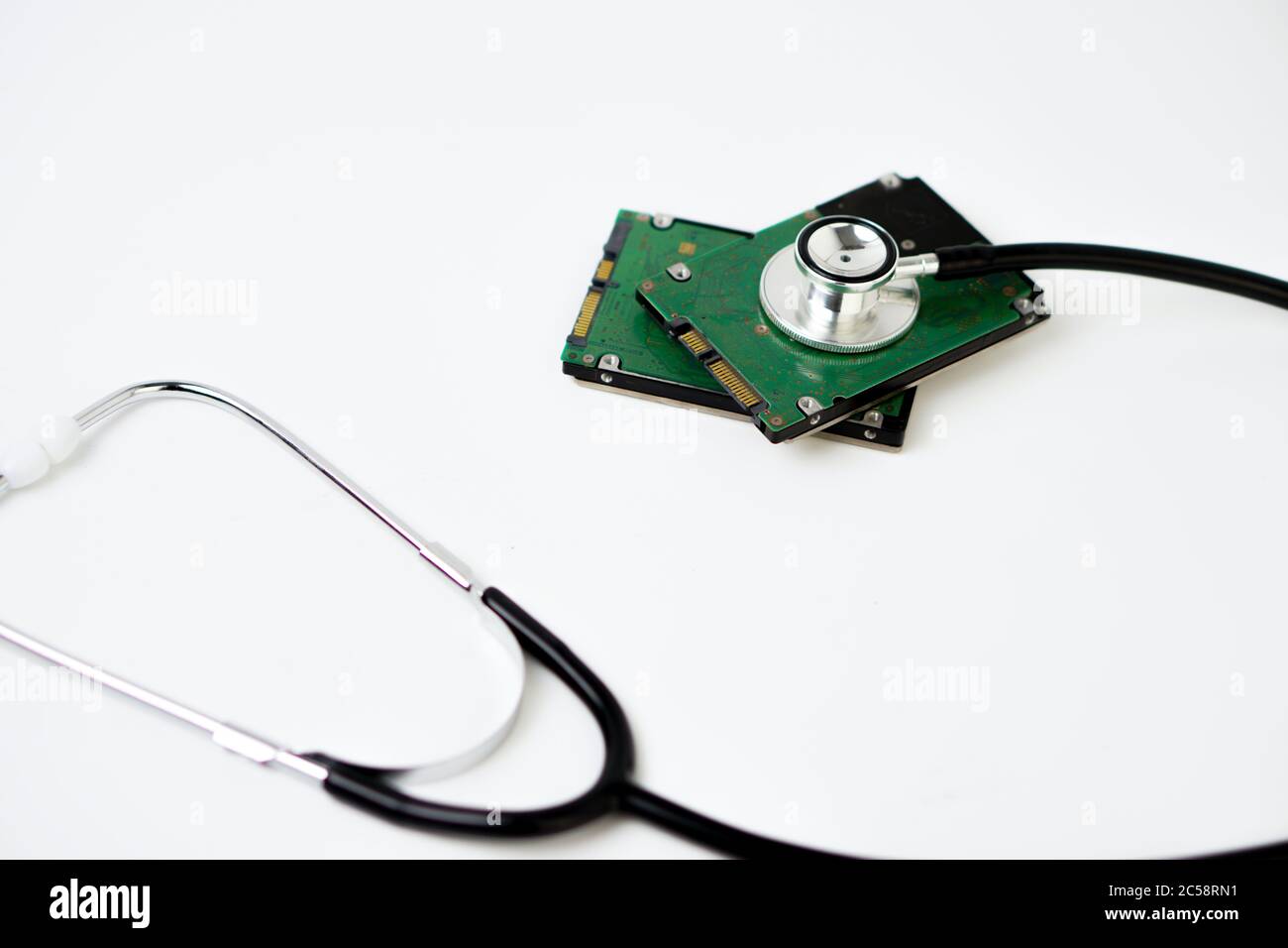 A hard disk with a stethoscope isolated on white background. Recovery ...