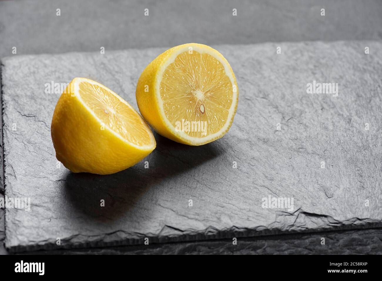 Fresh lemon on a grey stone board Stock Photo - Alamy