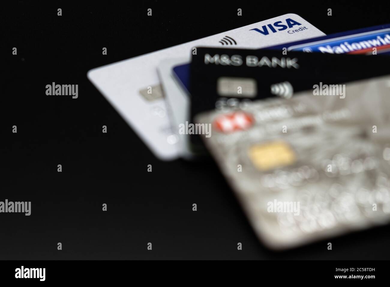 Stack of credit and debit cards from well-known finance companies ...
