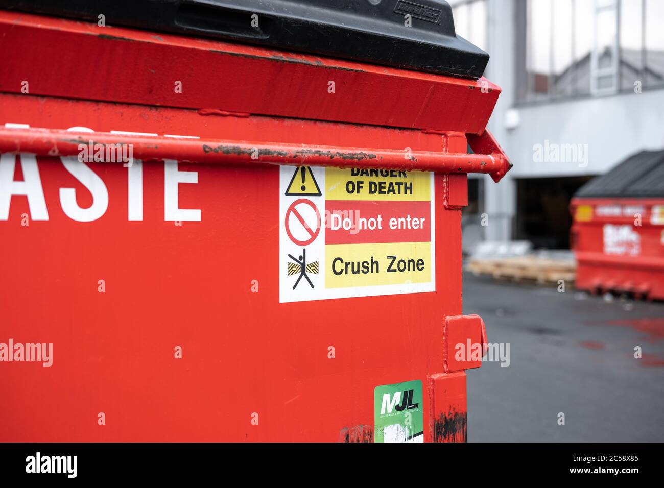 Over flowing industrial waste bin seen full of used plastic bags. The ...