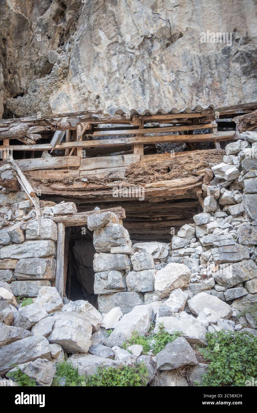 Old, ruined, stone building with door opening and exposed, decaying ...