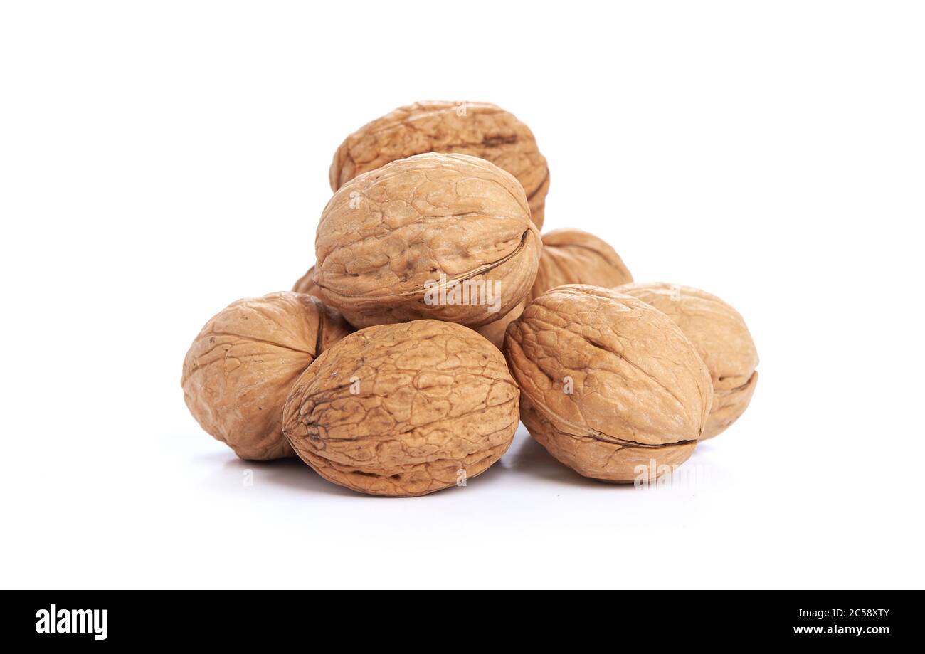 Heap of walnuts isolated on white background Stock Photo - Alamy