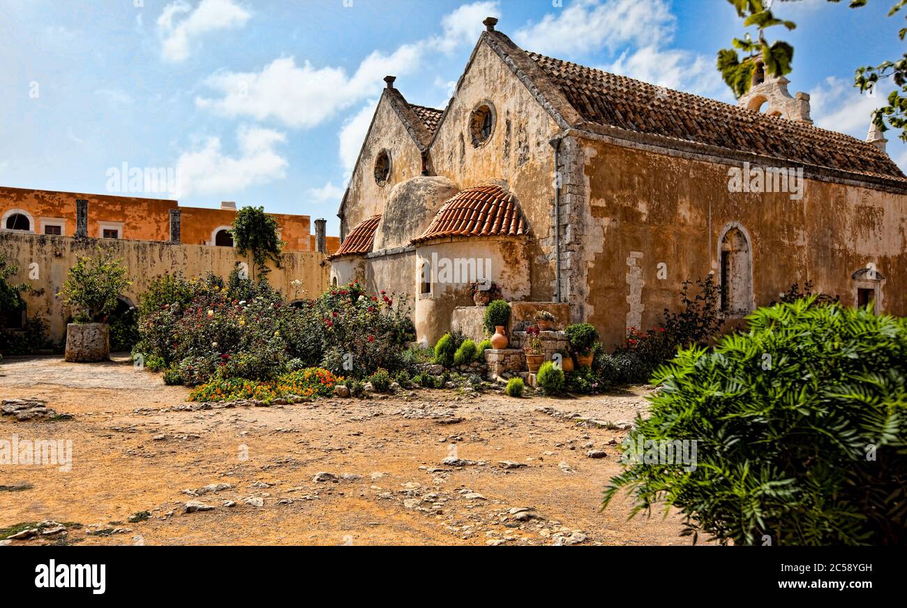Arkadi Monastery in southern Crete Greece with palm trees, urns and ...