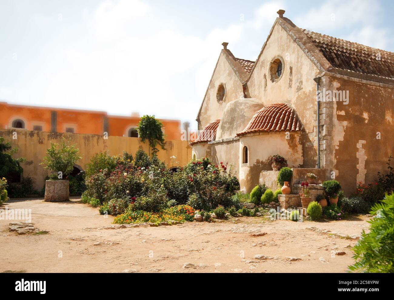 Arkadi Monastery in southern Crete Greece with palm trees, urns and ...