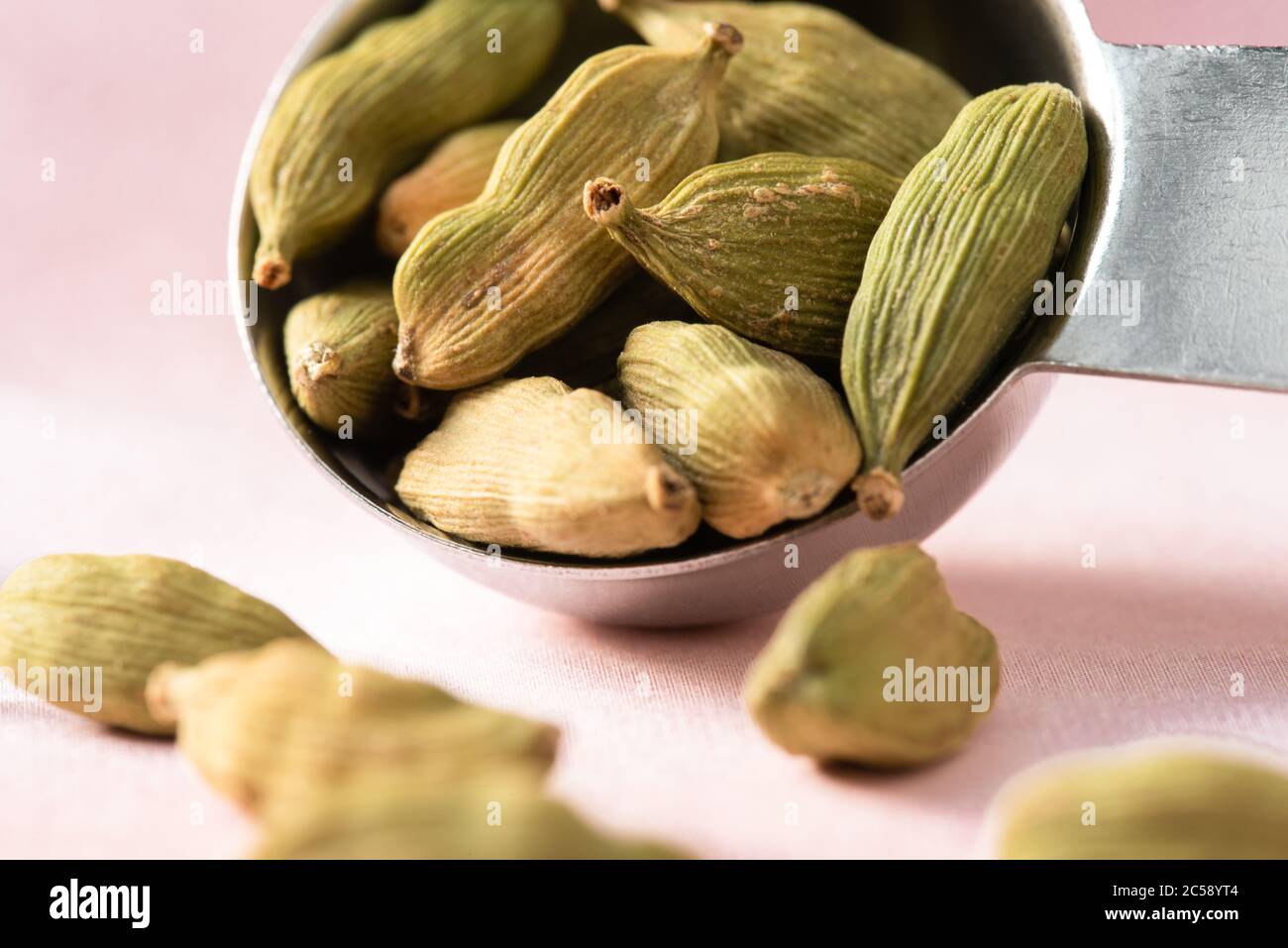 Green Cardamom Spilled from a Teaspoon Stock Photo - Alamy