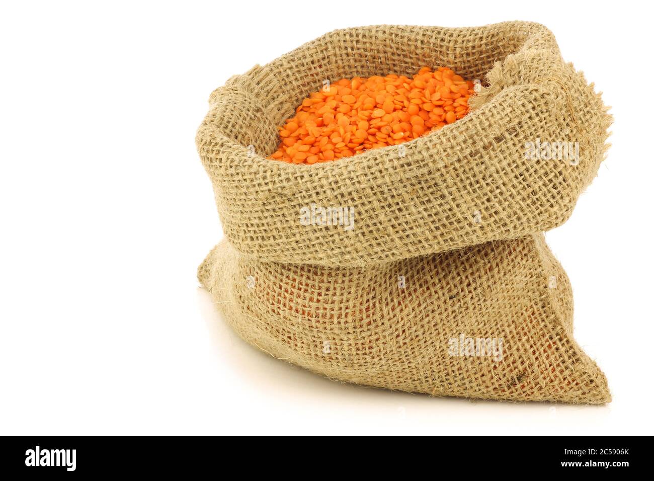 red lentils in a burlap bag on a white background Stock Photo - Alamy