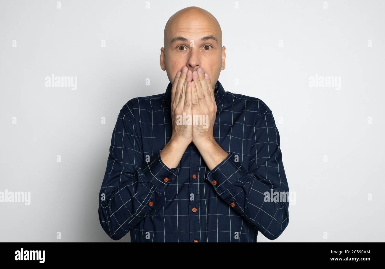 surprised bald man isolated on grey studio background Stock Photo - Alamy