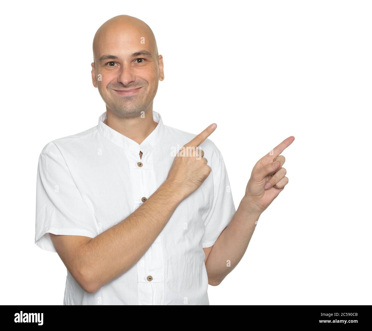 Happy handsome bald man in casual shirt pointing away and smiling while ...