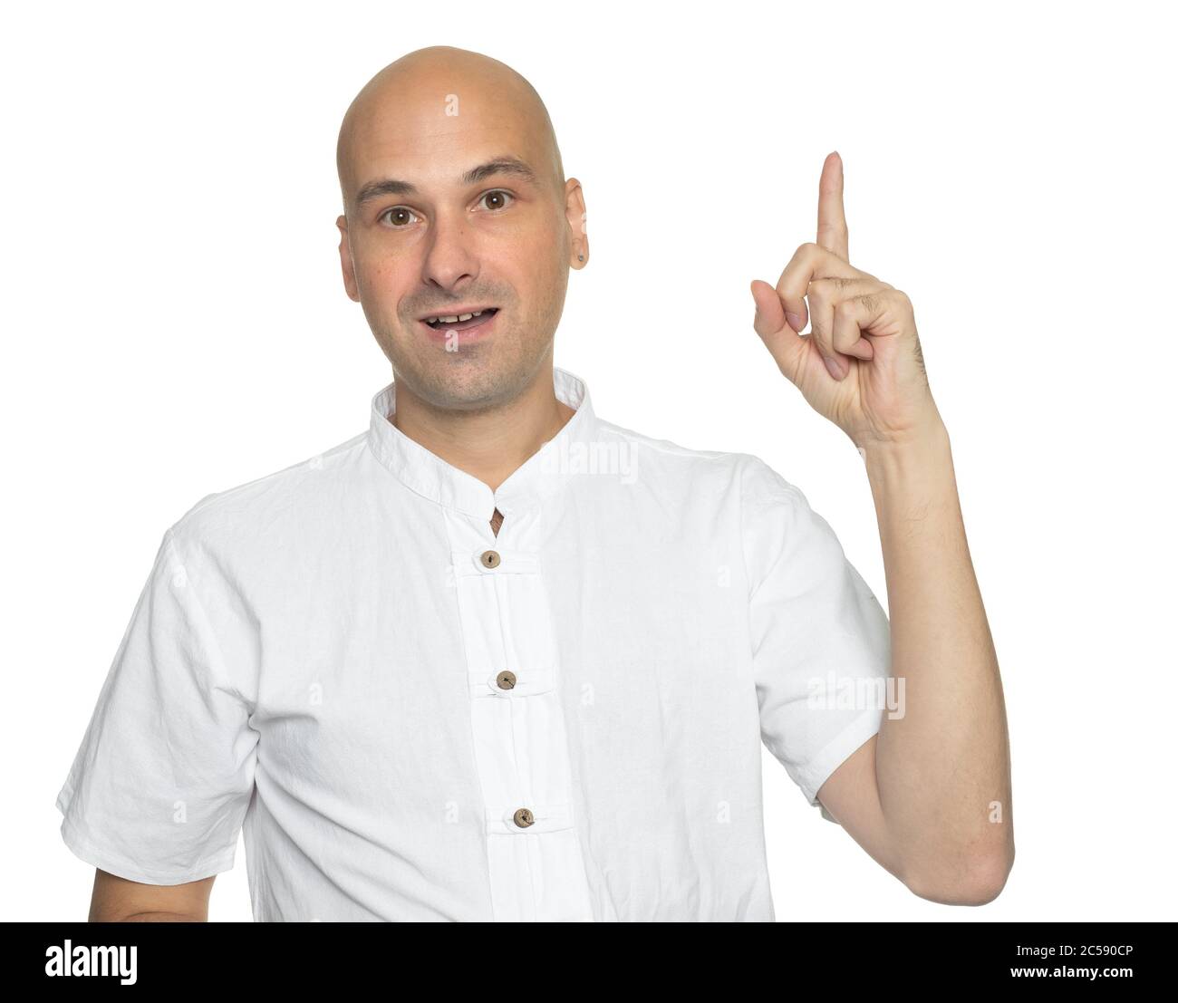 Bald man is pointing upwards in studio and looking at camera. isolated ...